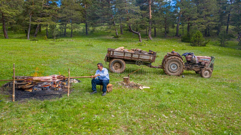 Elderly Turkish Man Roasting Lamb Over Open Fire in Traditional Style ...