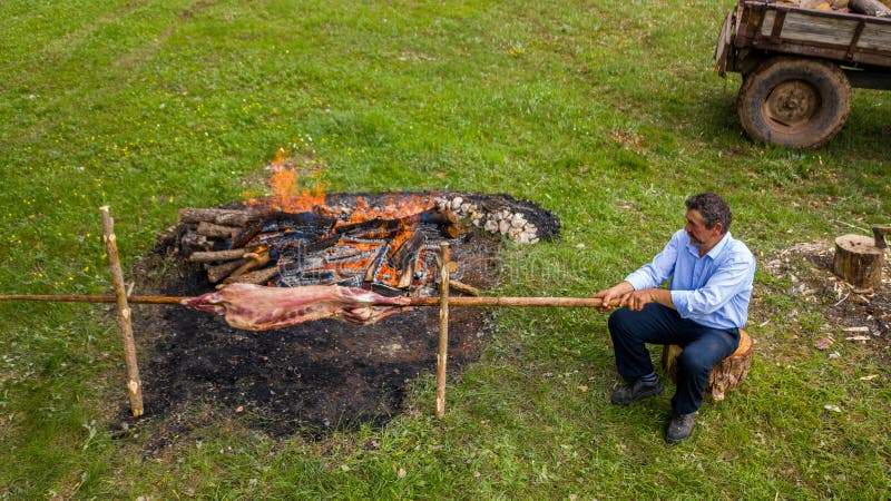 Elderly Turkish Man Roasting Lamb Over Open Fire in Traditional Style ...
