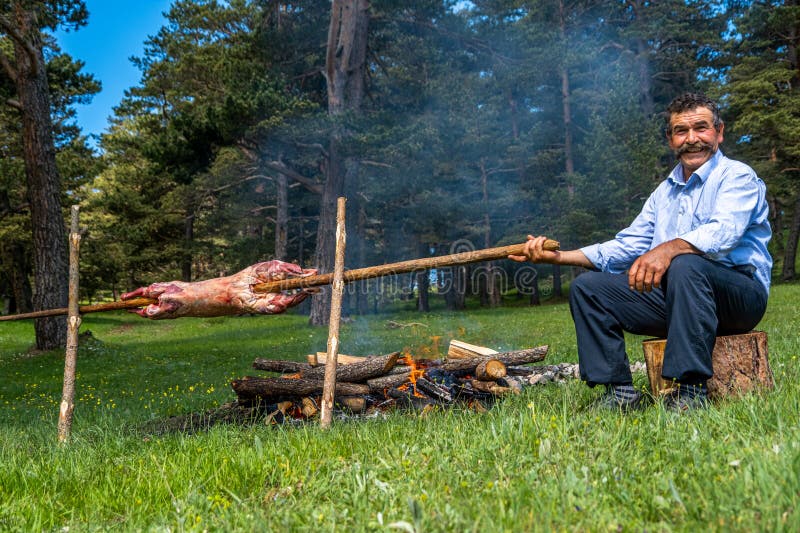 Elderly Turkish Man Roasting Lamb Over Open Fire Traditional Style ...