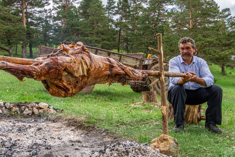 Elderly Turkish Man Roasting Lamb Over Open Fire in Traditional Style ...
