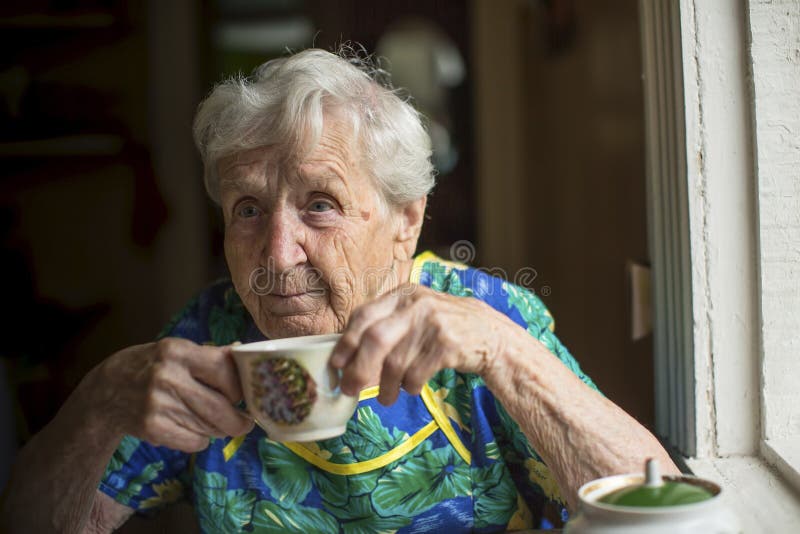 Elderly Woman Alone Drinking Tea. Happy. Stock Image - Image of person ...