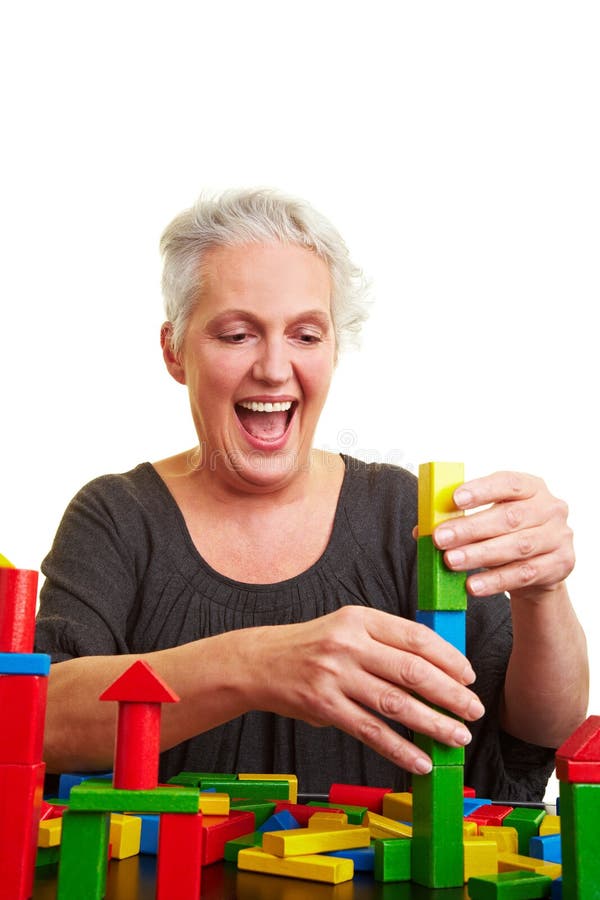 Elderly Woman Building a Brick Stock Photo - Image of block ...