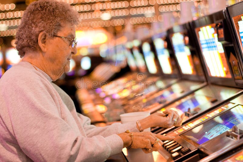 Elderly Woman Gambling on Slot Machine Stock Photo - Image of gambling ...