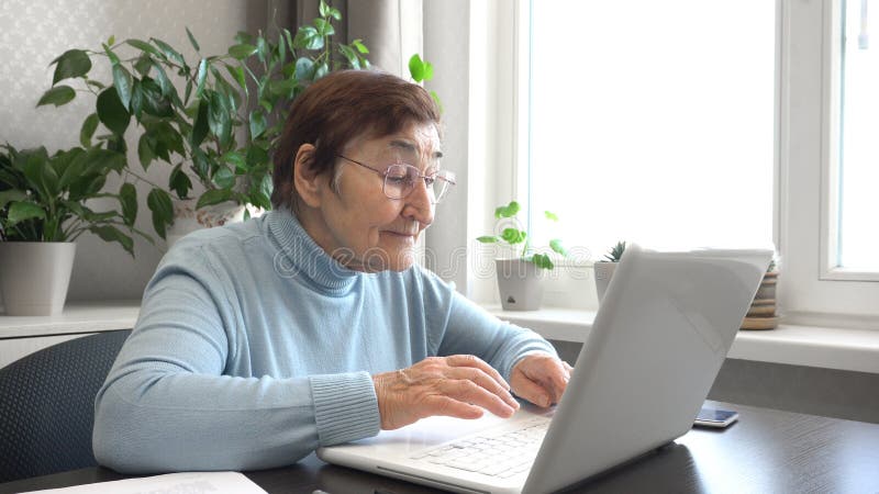 Elderly Woman in Glasses Working on Computer at Home Stock Image ...