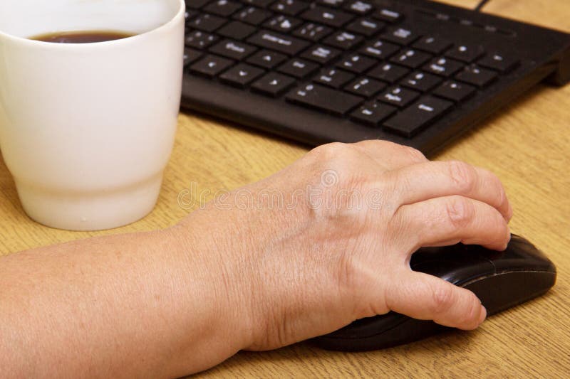 An Elderly Woman Hand on a Computer Mouse. the Old Grandmother Works ...
