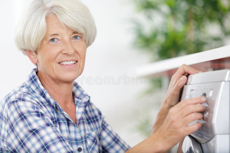 Elderly Woman Next To Washing Machine Stock Photo - Image of laundry ...