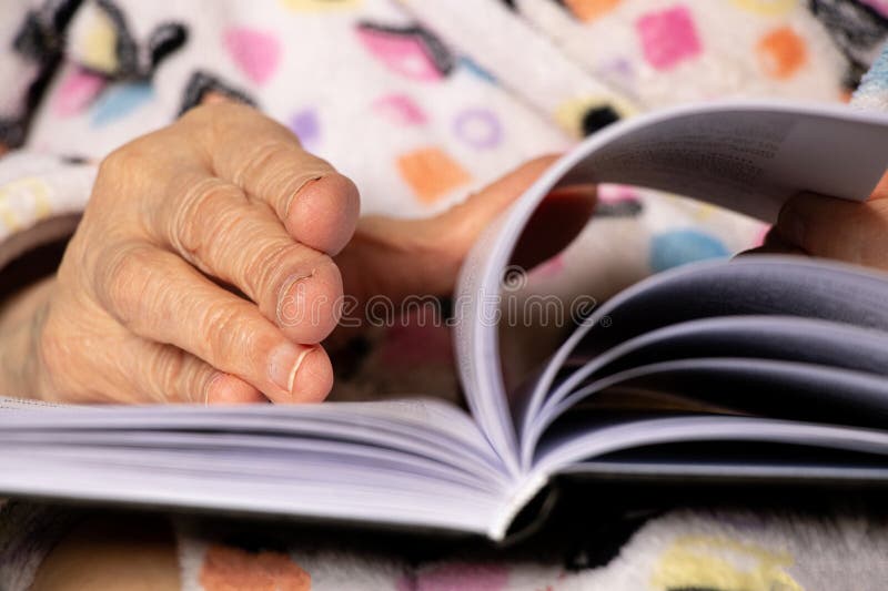 An Elderly Woman Opened a Book on the Table at Home Stock Photo - Image ...