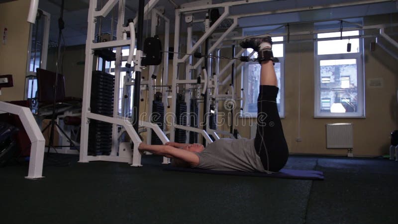 Elderly Woman Performs Kinesiological Exercise for the Lumbar Region on ...
