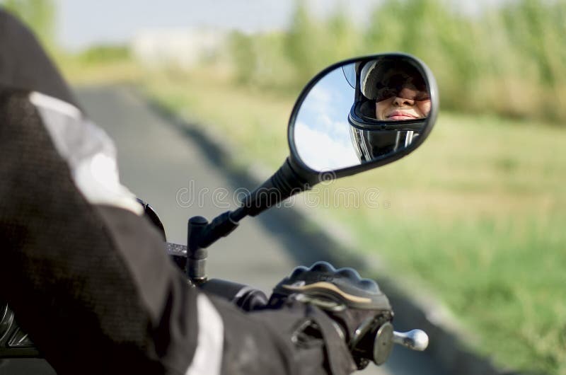 An Elderly Woman Rides a Motorcycle. Reflection in the Mirror while ...