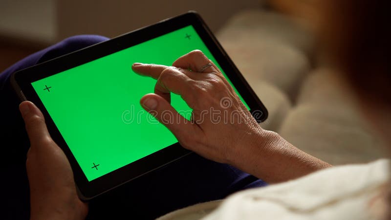 Elderly Woman Using a Digital Tablet PC with Green Screen, Back View ...
