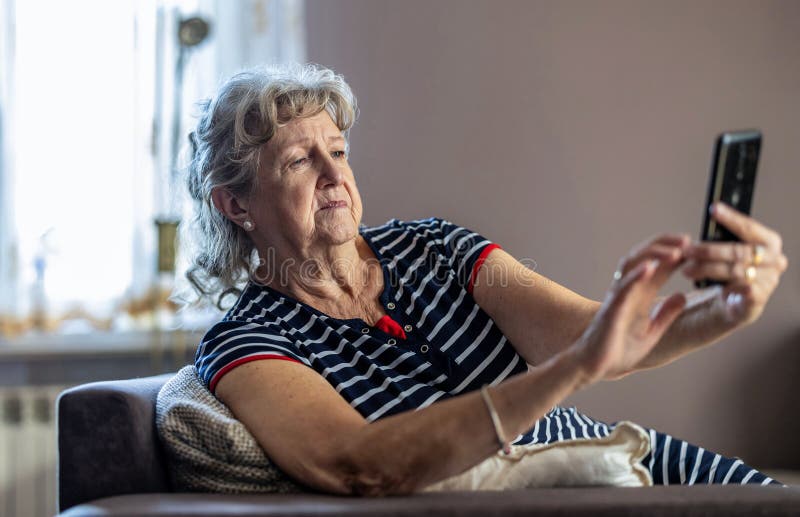 Elderly Woman Using Mobile Phone at Home Stock Photo - Image of ...