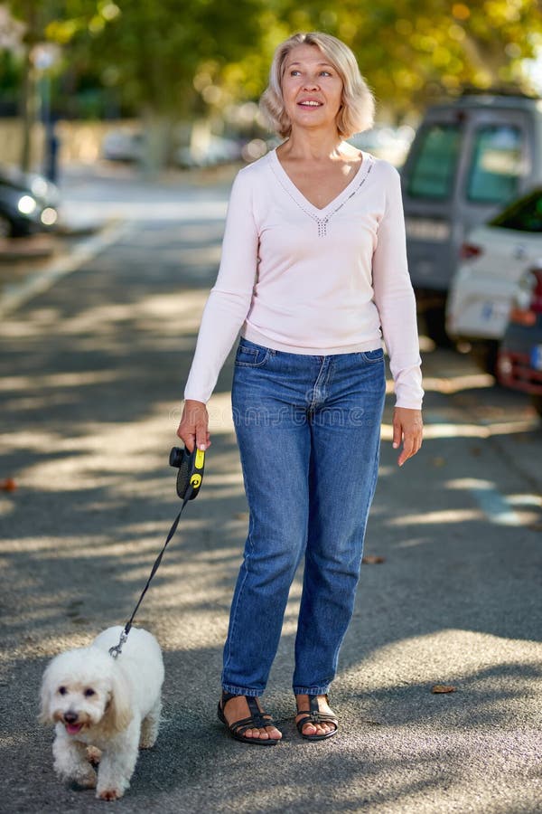 Elderly Woman Walking with a Dog Outdoors. Stock Photo - Image of ...