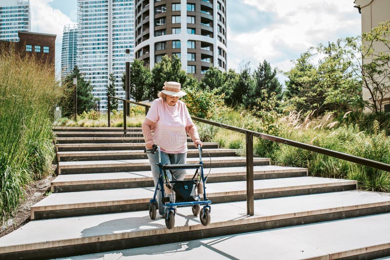 Elderly Woman Walking Down the Stairs with Rollator, Running Errands ...