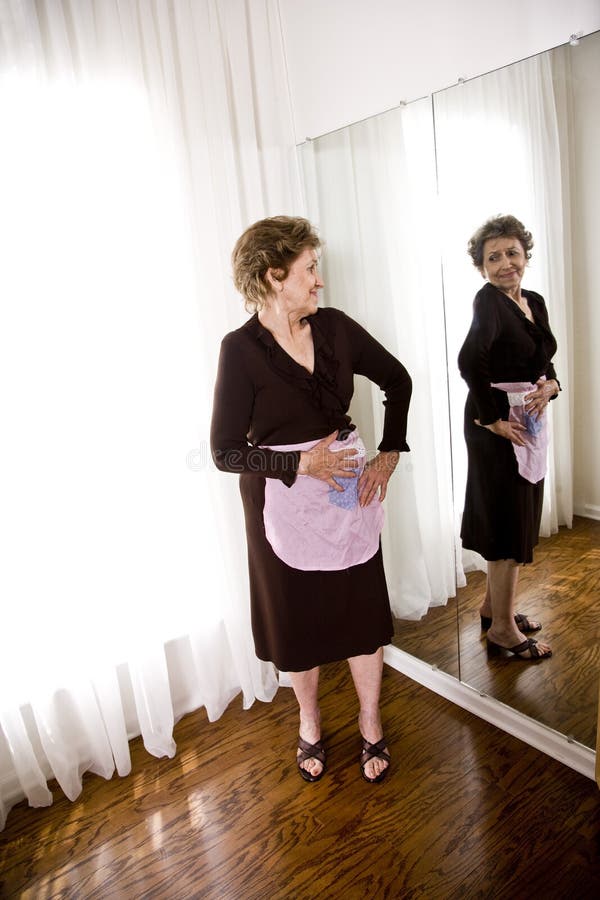 Elderly Woman Wearing Apron Stock Photo - Image of cheerful, standing ...