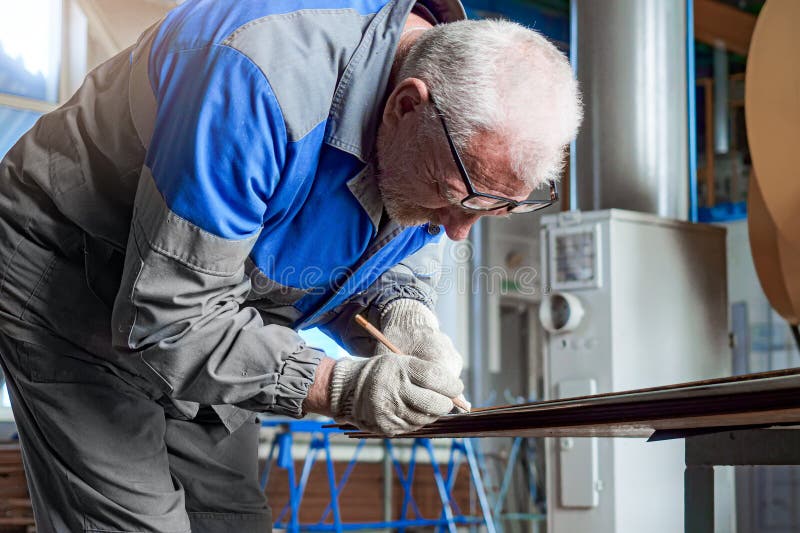 Elderly Worker in Glasses Works in Shop. Working Man Works in Workshop ...