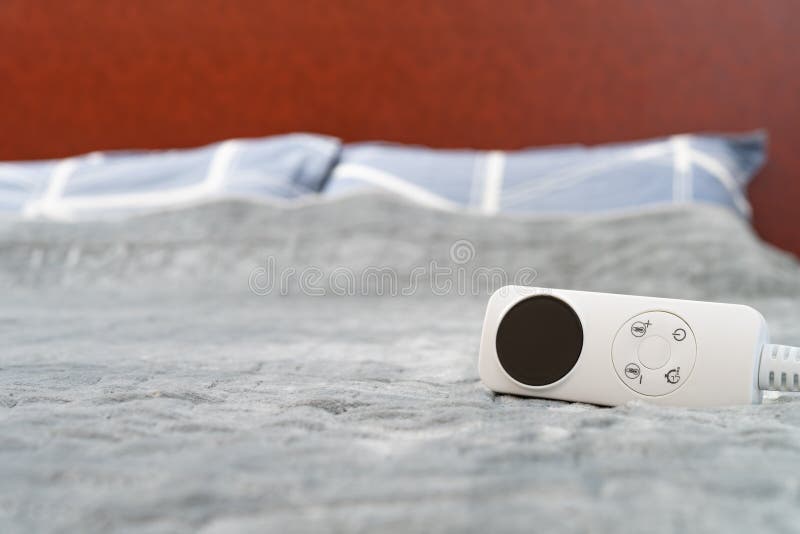 An Electric Blanket with Controller on a Bed at Horizontal Composition ...