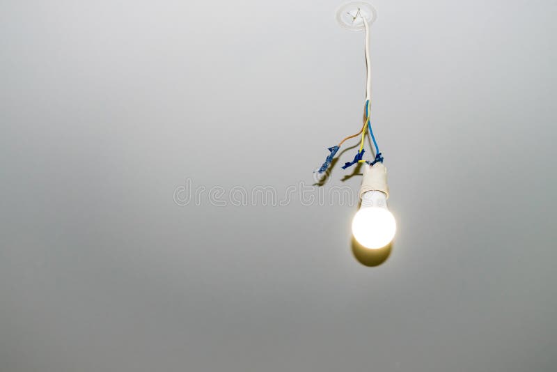 An Electric Bulb Hangs on the Wire. the Light Bulb is Connected To the ...