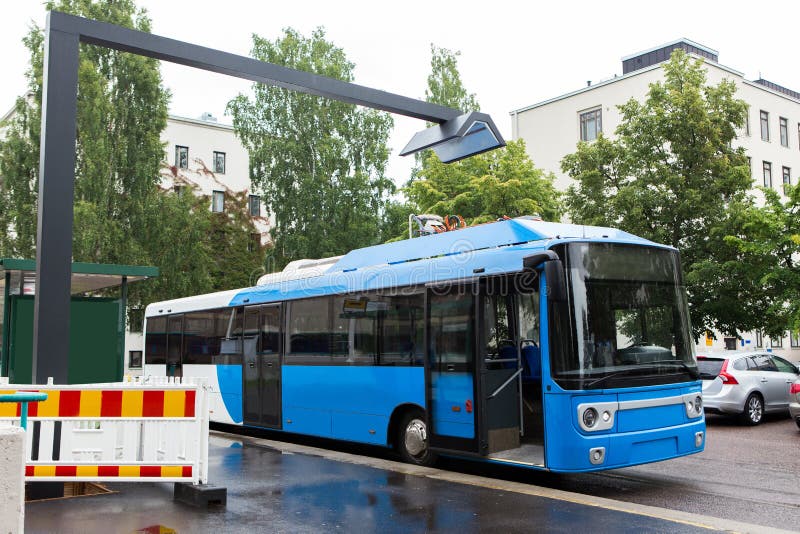 Electric bus at a stop stock image. Image of street - 104123467
