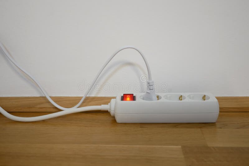 The Electric Cable is Plugged into a Power Strip Socket Extension Cord ...