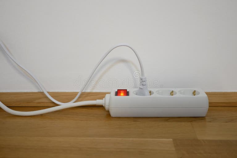 The Electric Cable is Plugged into a Power Strip Socket Extension Cord ...