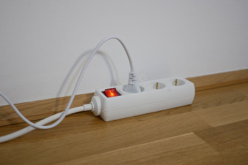 The Electric Cable is Plugged into a Power Strip Socket Extension Cord ...