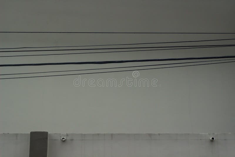 Electric cableon the wall stock photo. Image of high - 98994136
