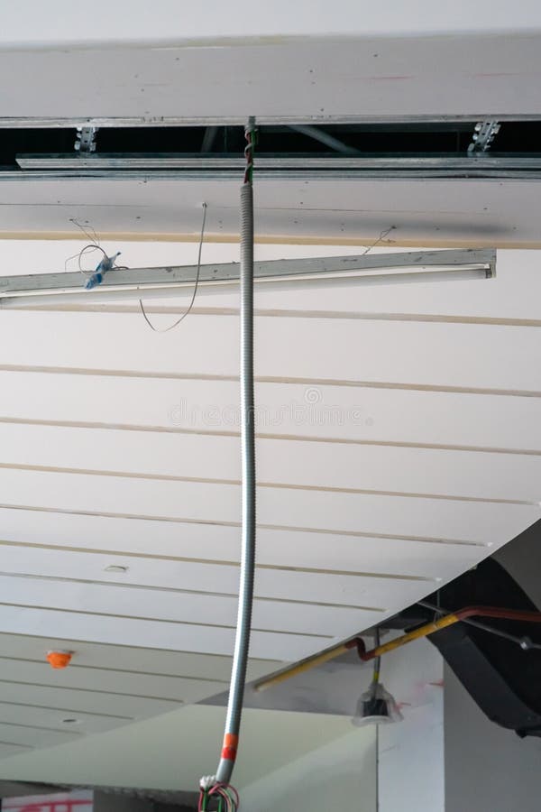 Electric Cables Hanging from Ceiling in a Construction Site. Work in ...