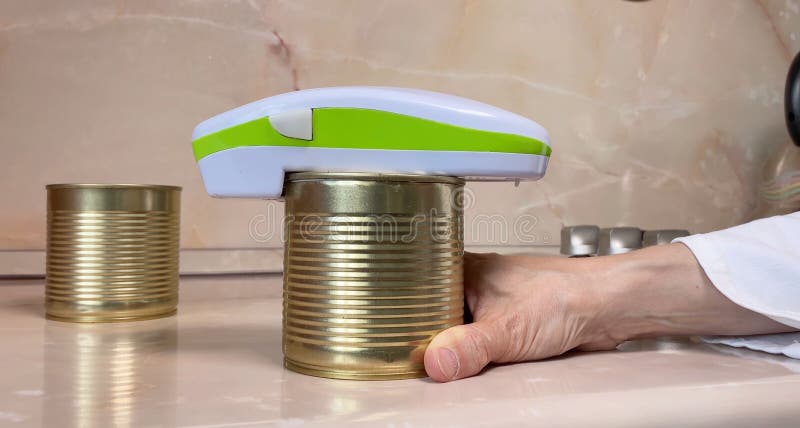 Electric Can Opener and Canned Goods on Table Stock Photo - Image of ...