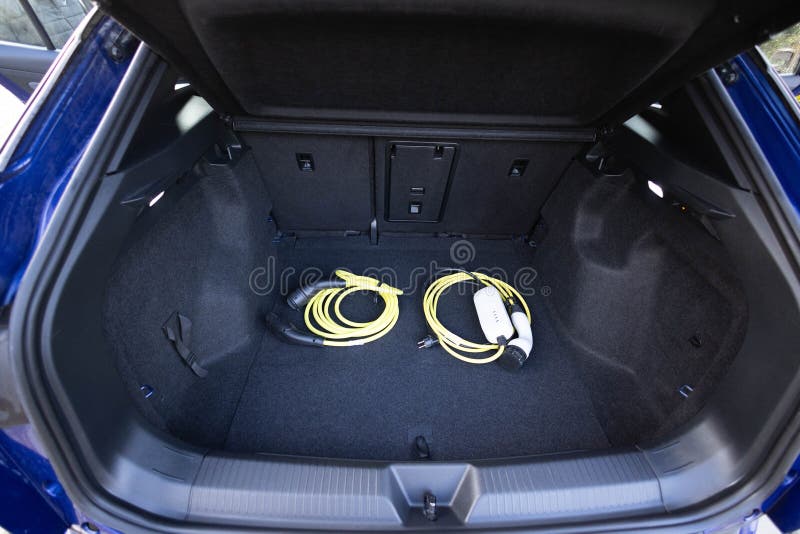 Electric Car Charger in Car Trunk. Trunk with Charging Cables. Modern ...