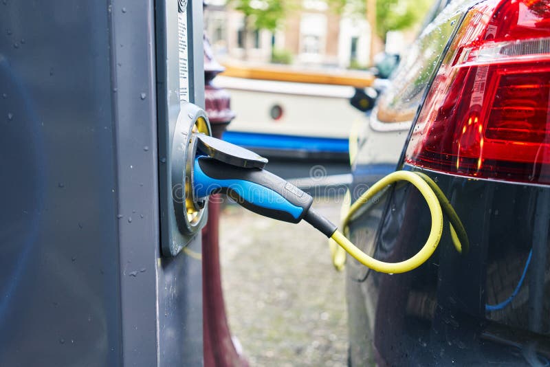 Electric Car Charging at Street Stock Photo - Image of charger ...