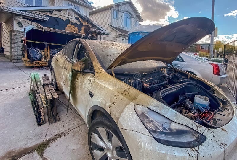 An Electric Car with Fire Damage in from a House Garage. Editorial ...
