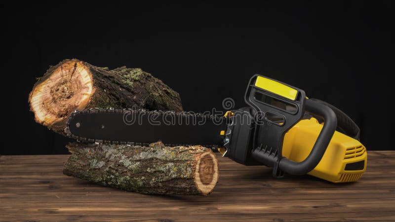 An Electric Chain Saw and Two Sawn Logs on a Wooden Table Stock Image ...