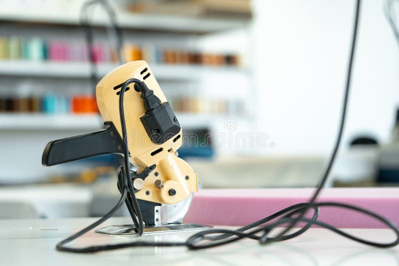 Electric Cutting Fabric Machine on Workbench in Sewing Factory Stock ...