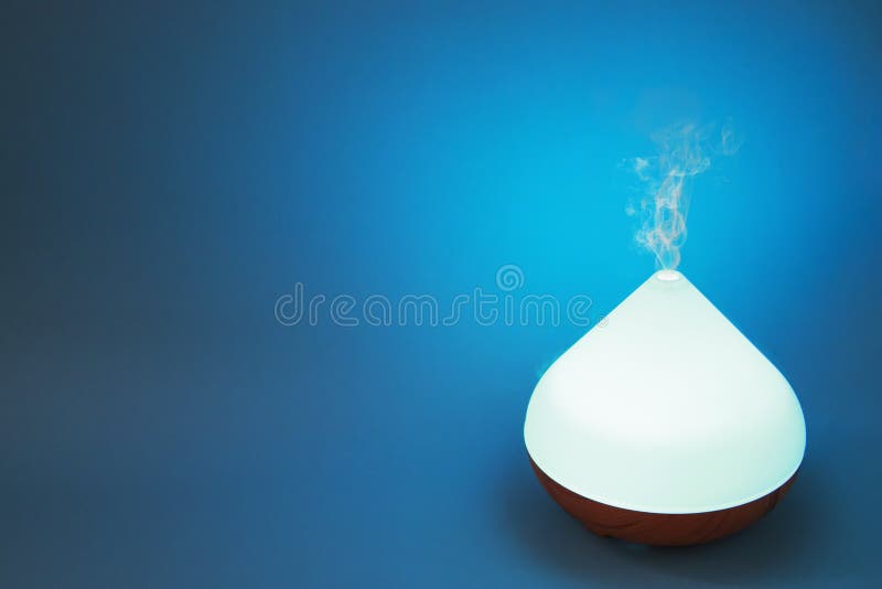 Electric Essential Oil Diffuser on Blue Background Stock Photo - Image ...