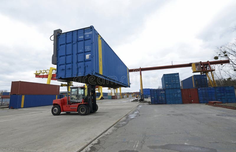 Electric Forklift Loader Carrying Cargo Container in a Container Yard ...