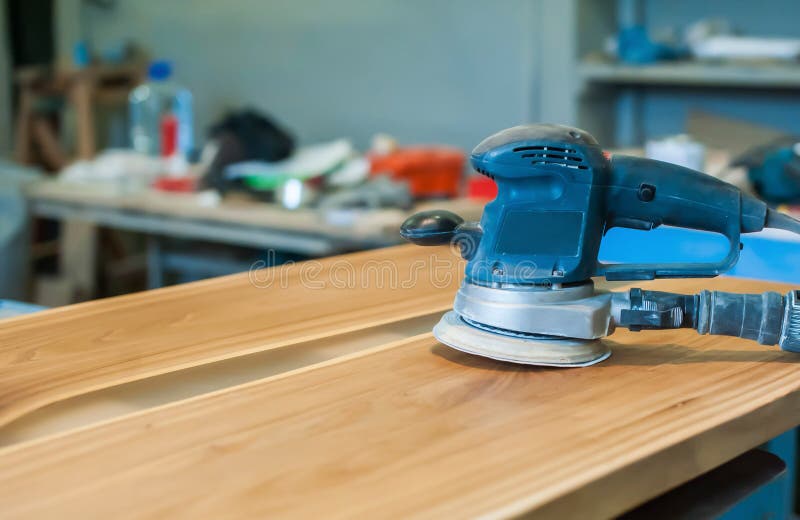 Electric Grinder on a Board in a Carpentry Workshop. Close-up Stock ...