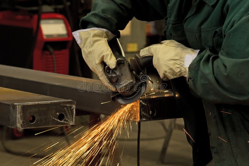 Worker with a Grinding Machine Processes a Gear Wheel - Production of ...