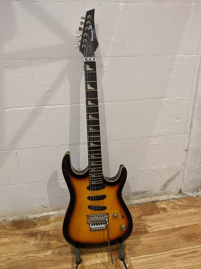 Electric Guitar in Brown and Black and Wood Floor Editorial Stock Image ...