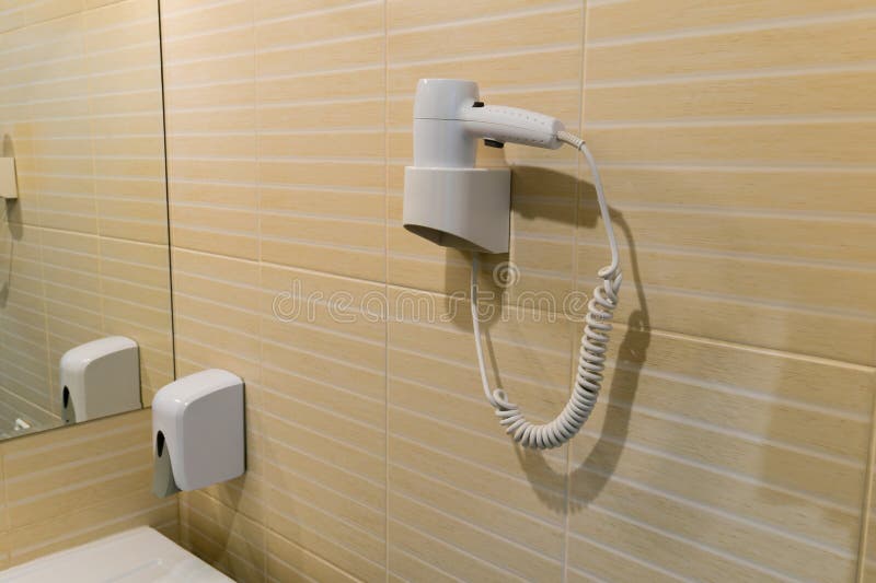 Electric Hair Dryer on a Holder Mounted on a Ceramic Tile Wall Stock ...