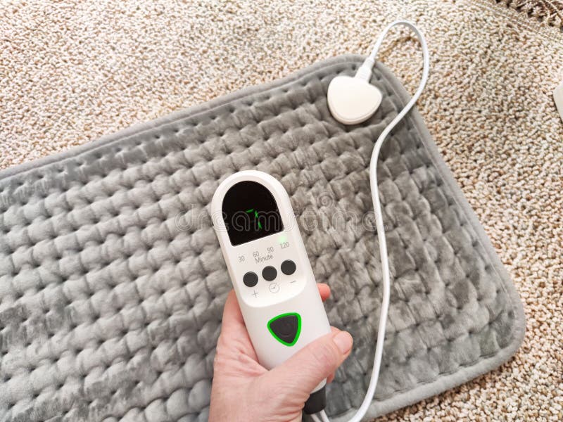Electric Heating Mat with Remote Control in a Cozy Indoor Setting Stock ...