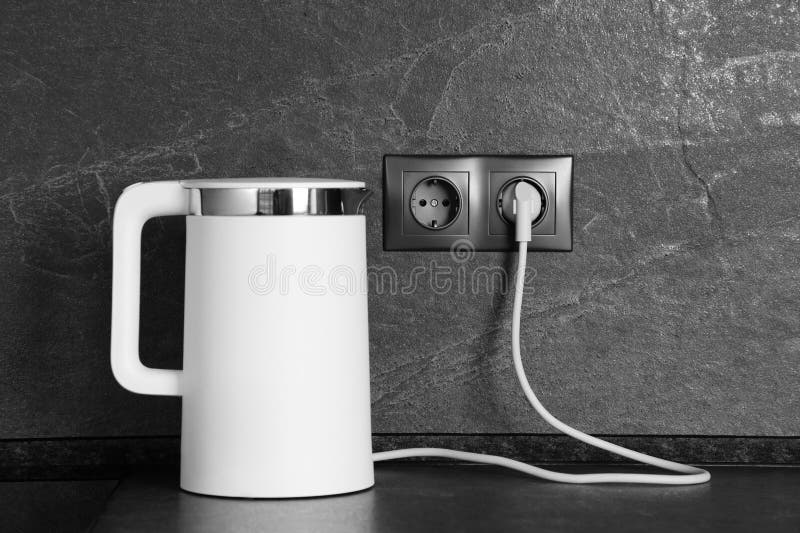 Electric Kettle Plugged into Power Socket on Dark Grey Wall Indoors ...