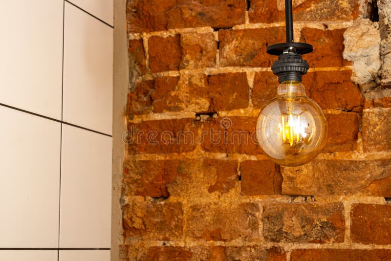 Electric Lamp on the Background of an Old Wall of Red Brick and Tile ...