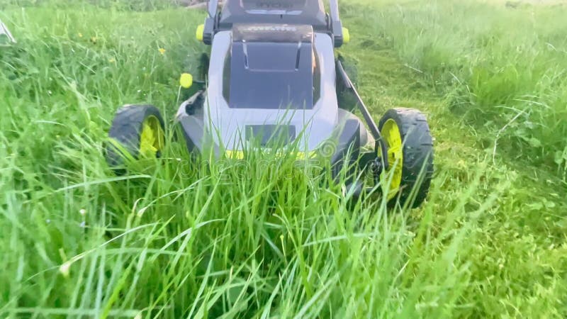 Electric Lawn Mower Cutting Grass Stock Video - Video of lawnmower ...