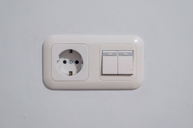 Electric Light Switch and Electrical Power Socket on the Empty Wall ...