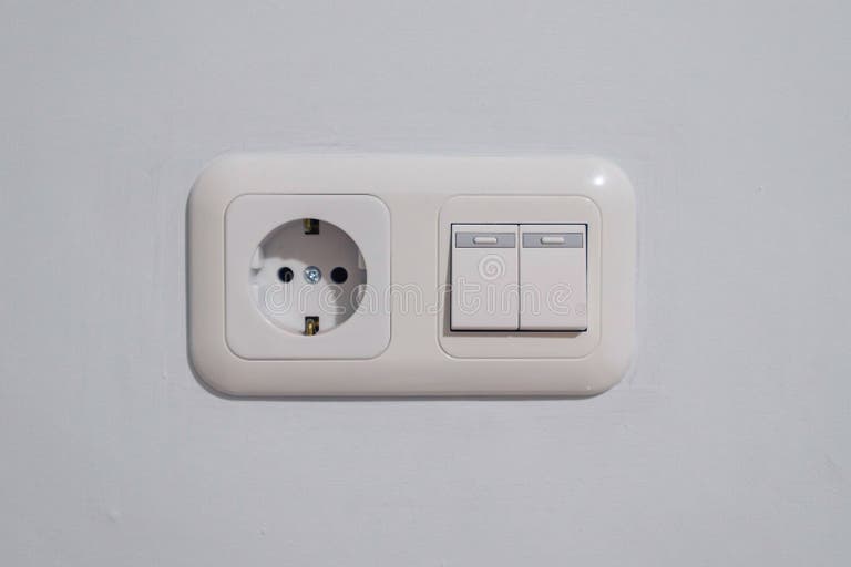 Electric Light Switch and Electrical Power Socket on the Empty Wall ...