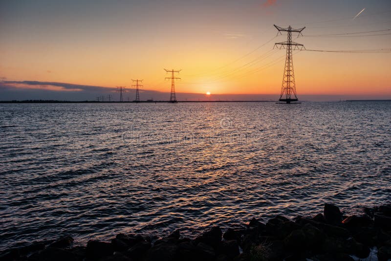 Electric Line Above Water during a Fantastic Sunset Stock Photo - Image ...