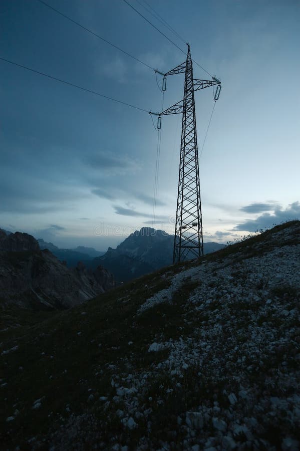 High Voltage Tower In Mountains At Sunset. Electricity Pylon System ...