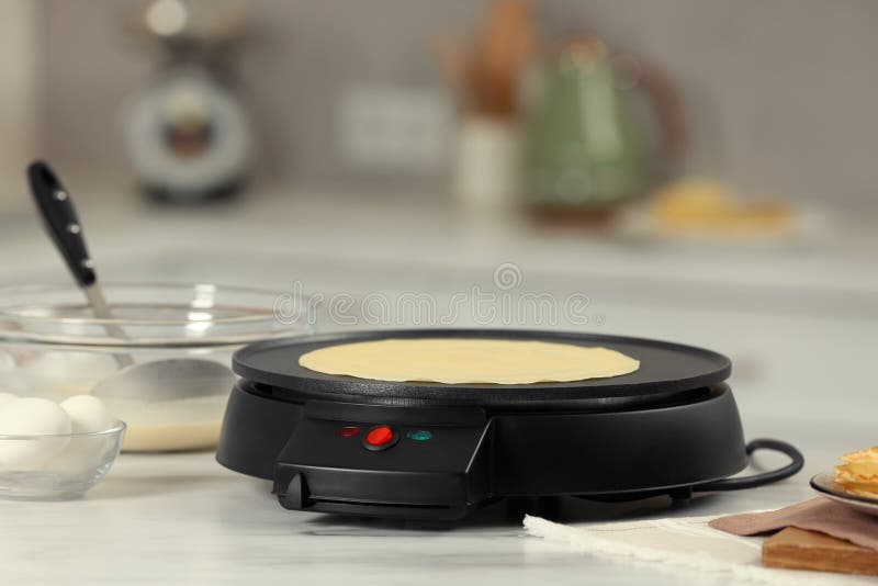 Electric Maker with Crepe and Ingredients on White Marble Table in ...