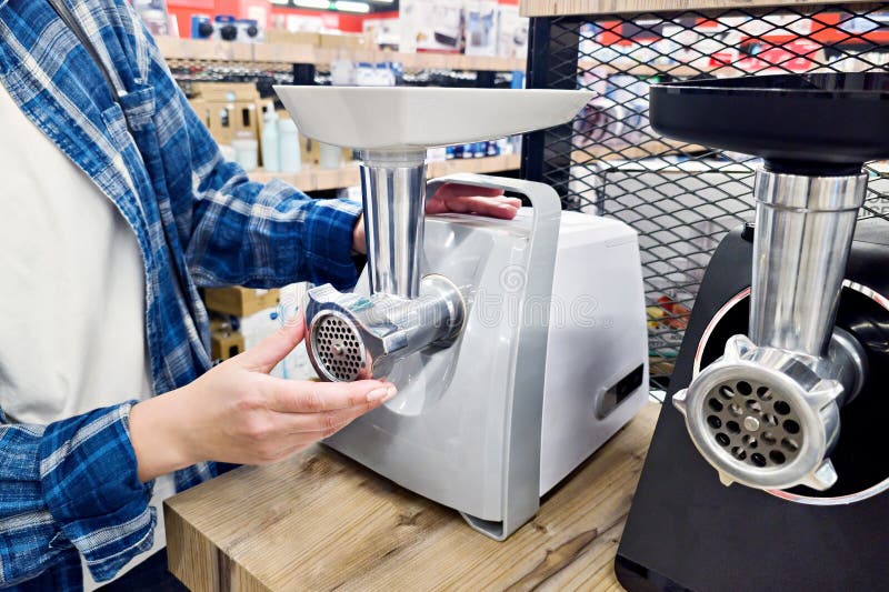 Electric Meat Grinder in Woman Hands in Store Stock Photo - Image of ...