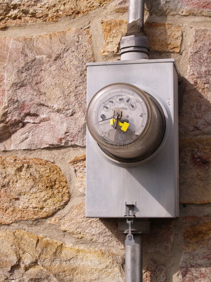 Electric Meter by a Stone Wall Stock Photo - Image of wall, kilowatts ...
